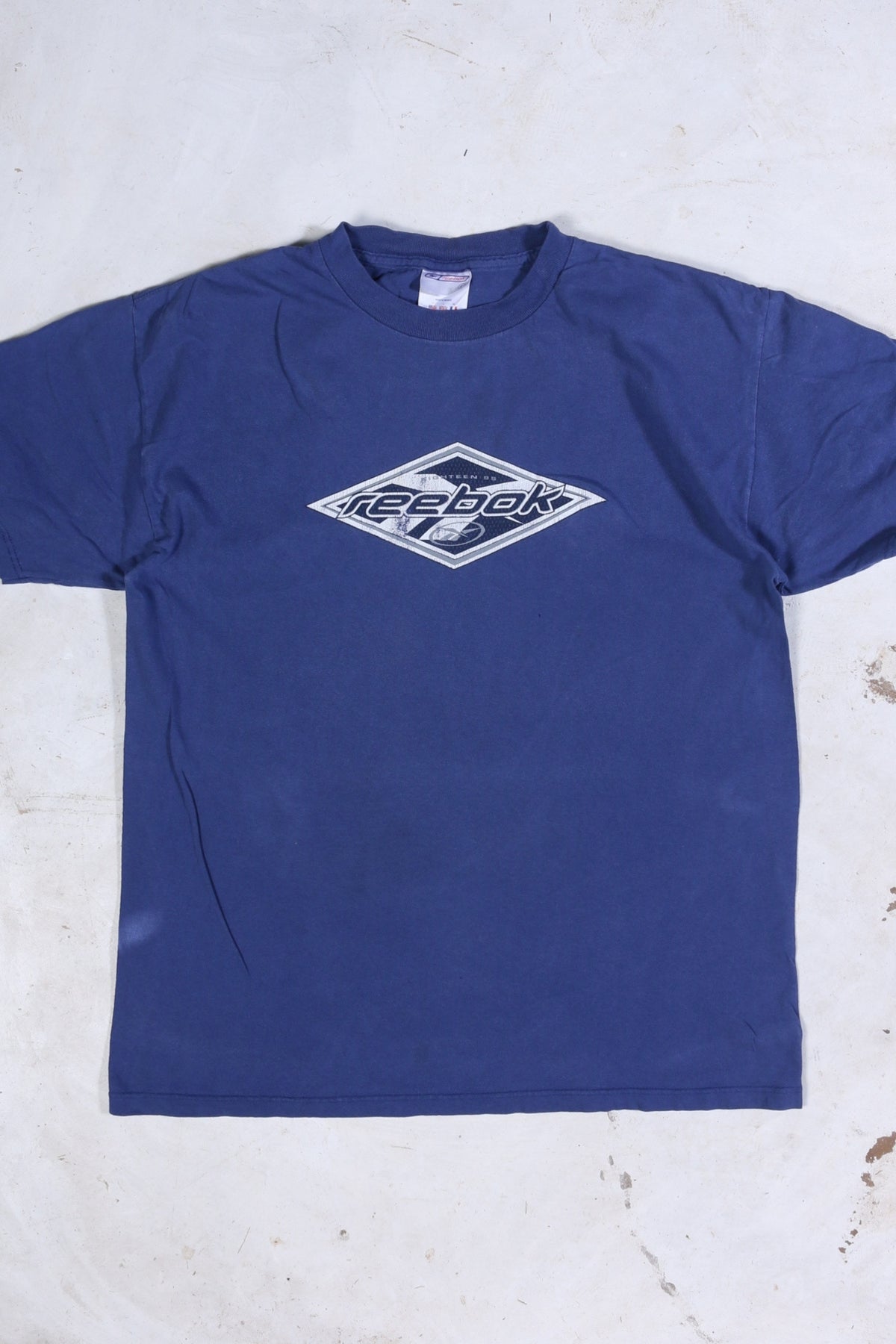 VINTAGE REEBOK TEE (M) *PINPRICK HOLE ON FRONT– Vintage Marketplace